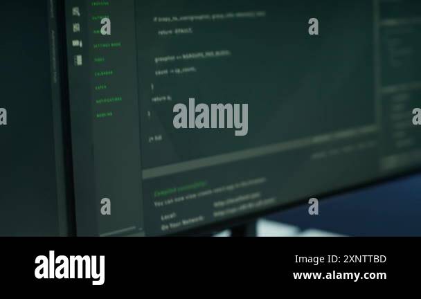 Extreme close up shot of computer displays on desk in server farm used for overseeing equipment ...