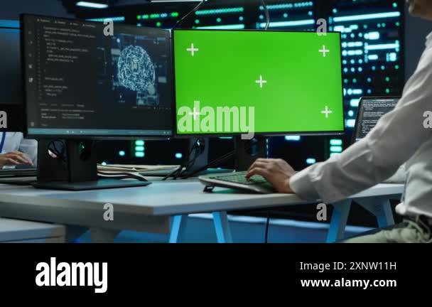 Engineer using AI tech on green screen PC to do checkup in server room. Zoom in of expert in ...