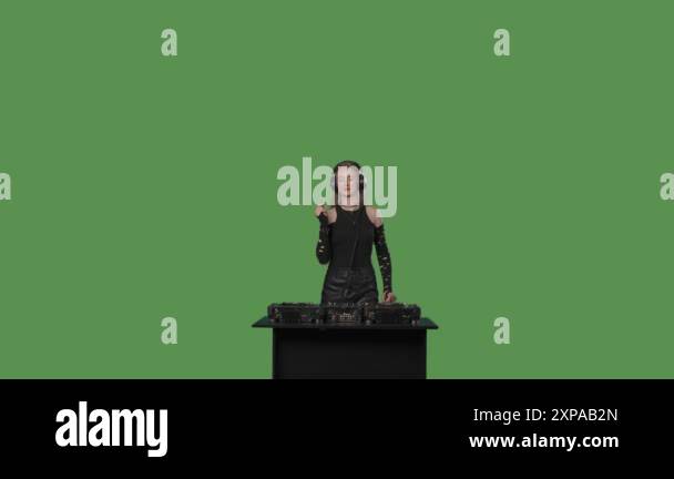 Dynamic video of a female DJ dressed in black at the console mixing ...