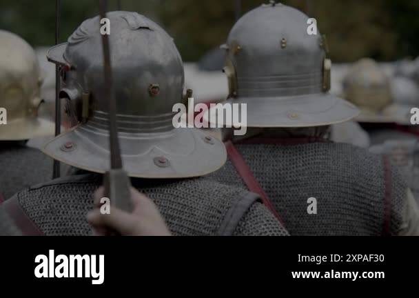Back view of medieval soldiers wearing armor and helmets during a ...