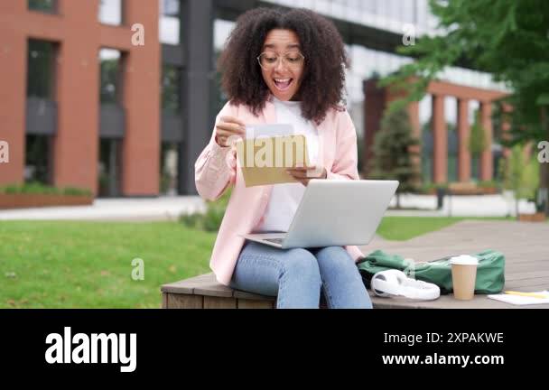 Happy excited african american female student celebrating success ...