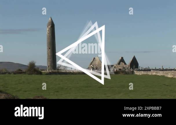 White triangle animation over ancient stone buildings and round tower ...