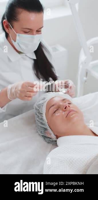 Facial forehead skin care anti-aging cosmetic treatment procedure in a ...