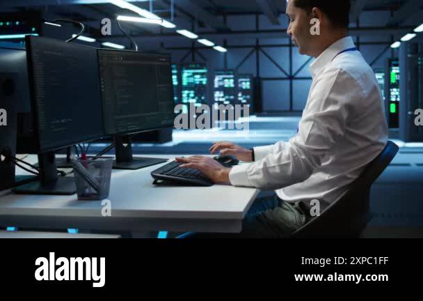 Engineer overseeing data center, making routine improvements and ...