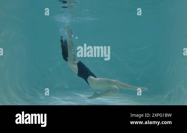 Skillful fit attractive female synchronized swimmer improving artistic ...