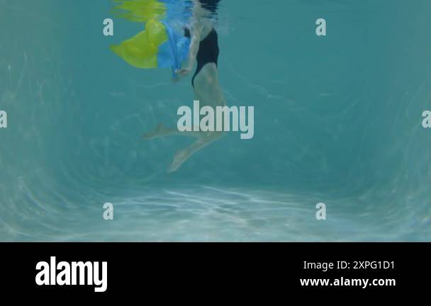 Elegant beautiful slim sportswoman with blue yellow cloth practicing ...