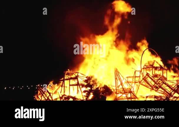 A dramatic image of a fierce fire burning intensely against the dark ...