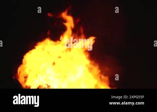 A dramatic image of a fierce fire burning intensely against the dark ...