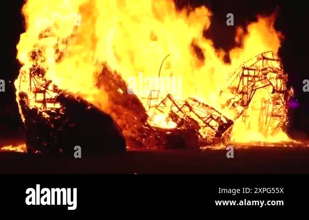 A dramatic image of a fierce fire burning intensely against the dark ...