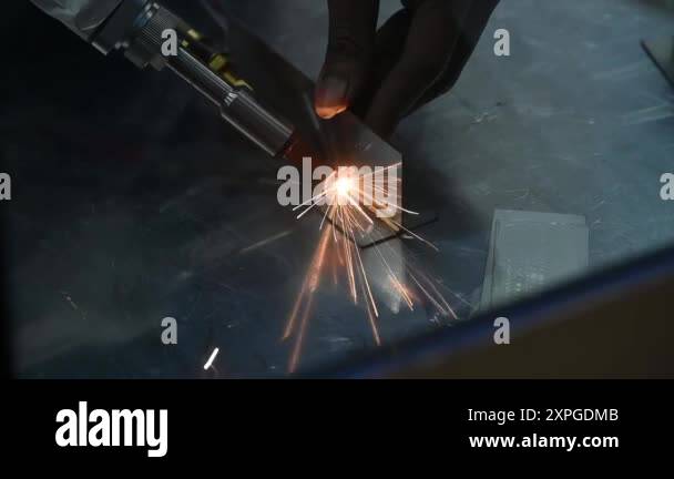 Close up scene the demonstration of laser welding operation. The high ...