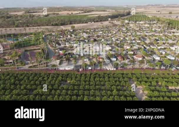 Starting with a sweeping view over fields and a vibrant caravan park ...