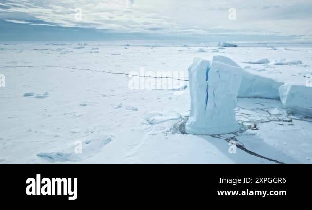 Antarctica cracked iceberg towering frozen ocean. Huge snow covered ice ...