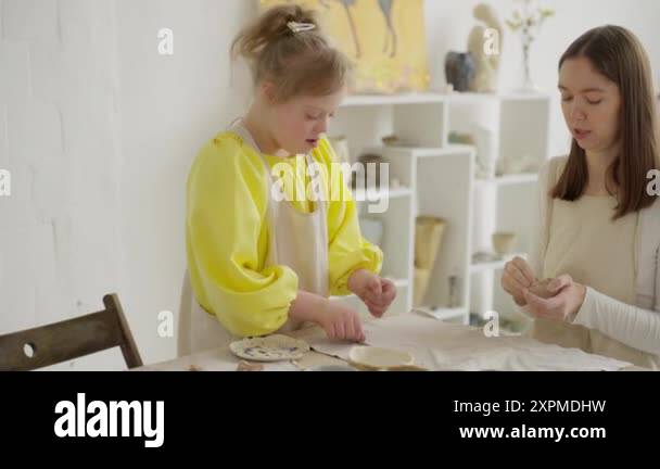 Girl with Down syndrome enjoys pottery class, making clay art with ...