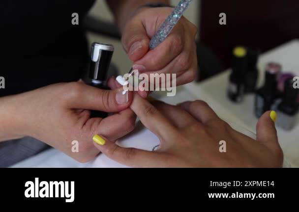 From above of crop unrecognizable manicurist doing nail art for female ...