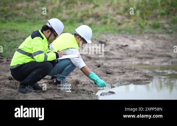 Environmental engineers work at water source to check for contaminants in water sources and ...