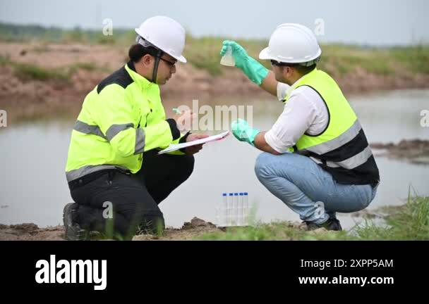 Environmental engineers work at water source to check for contaminants in water sources and ...