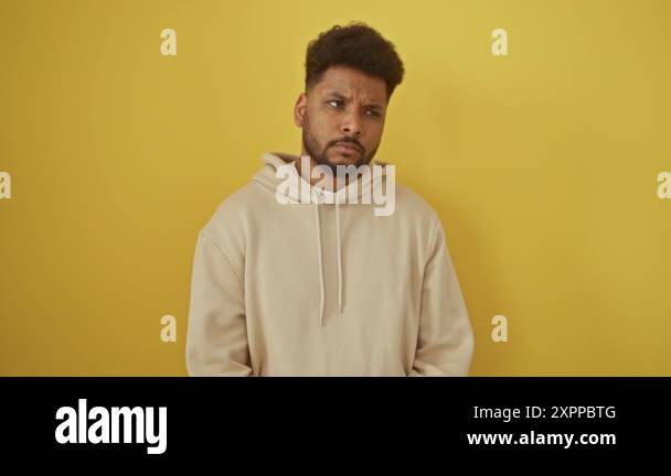 Cheerful african american man, rocking a yellow hoodie and emanating ...