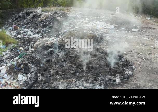 Garbage, fire burning and smoke in landfill. Also called trash, waste ...