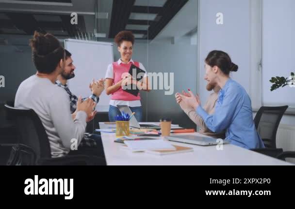 Diverse team of professionals applauding and showing appreciation for ...