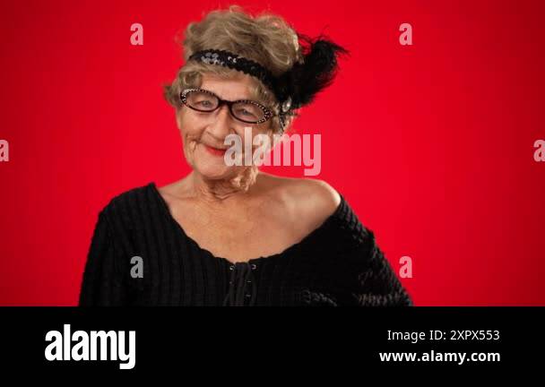 Funny portrait of happy elderly toothless senior woman wearing wig ...