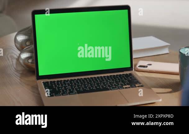 Chroma key laptop standing at wooden desk closeup zoom in. Unknown ...