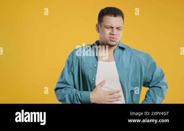African American Man squeezing belly with hands because of abdominal ...