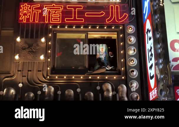 Tokyo , Japan - June 25, 24: Typical Japanese bar with a girl seating ...