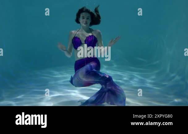 Elegant slim beautiful mermaid with long brown hair bring scared by ...