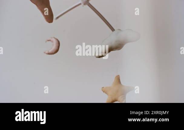 No people close-up of sensory baby mobile with soft toys hanging above ...