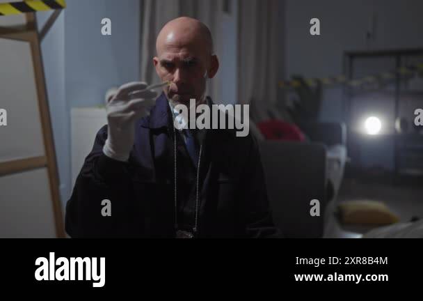 Detective examines evidence at crime scene, lighting a forensic house ...