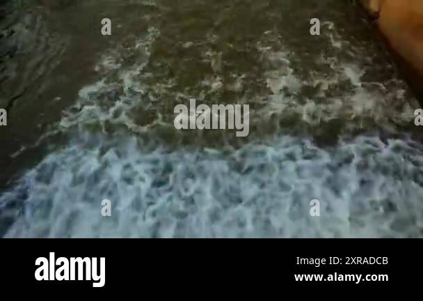 4k Tilt up view water foam falling. River irrigation system control ...