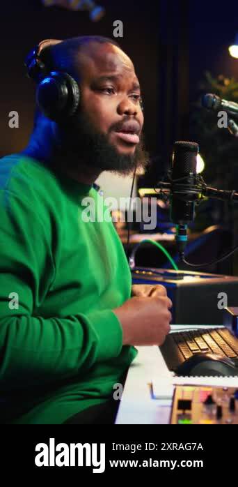 Vertical Video Confident artist singer performing a song on microphone ...