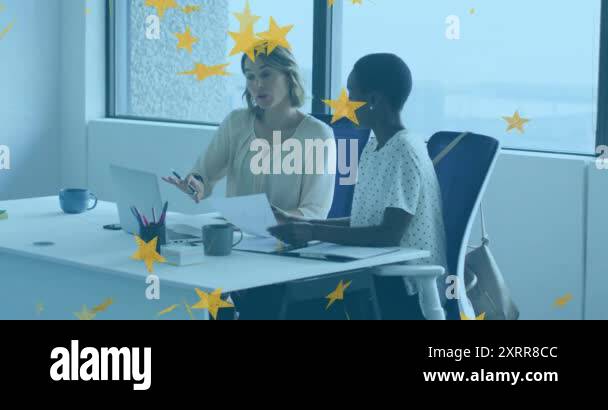 Discussing documents at desk, two women with star animation overlay ...