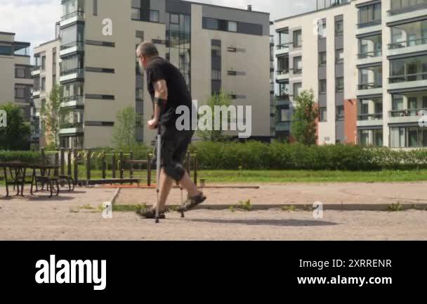 Mature man with bondage, medical splint, knee brace on the leg walking ...