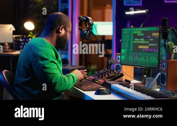 African american composer creating a new track for a project, using ...