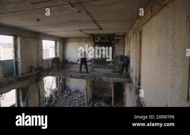 Team uses jackhammers in residential building, clears debris for ...