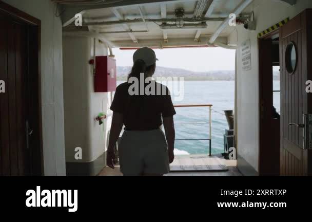 Female sailor observes urban landscape, tranquil water journey. Young ...