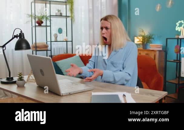 Displeased sad businesswoman using laptop notebook typing browsing ...