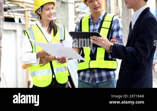Architect Asian team working with colleagues in the construction site ...