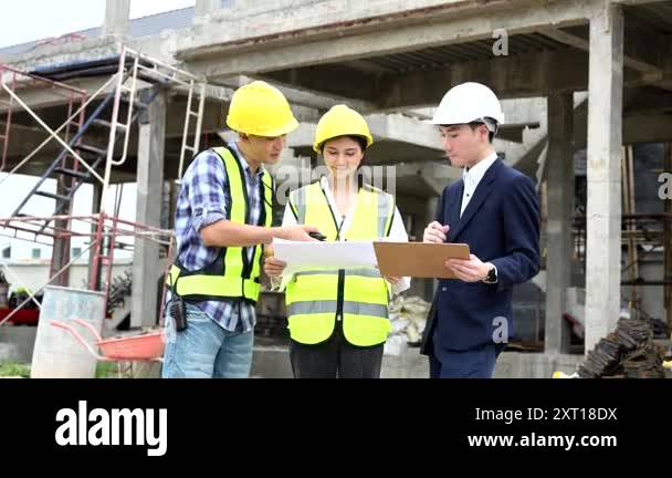 Architect Asian team working with colleagues in the construction site ...