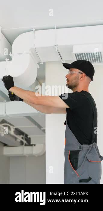 Hvac worker install ducted pipe system for ventilation and air ...