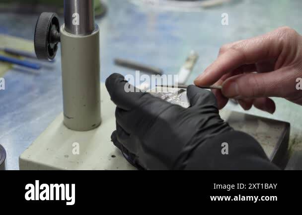 This video shows a close-up view of a silver coin being polished by ...