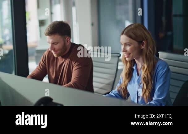 Positive colleagues communicating at workplace closeup. Smiling woman typing laptop sharing ...