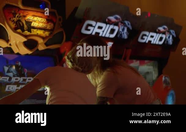 A back view shot captures two women happily conversing while playing a ...