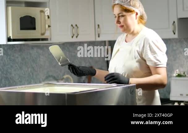 workers packaging freshly processed dairy products and labeling them ...