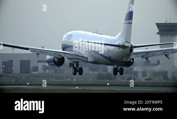 Slow motion video of a passenger plane landing on an airport runway ...