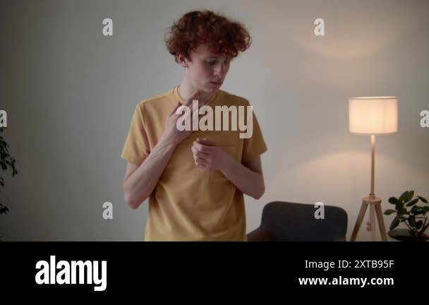 Medium shot of young gen Z guy with curly hair in plain t-shirt ...