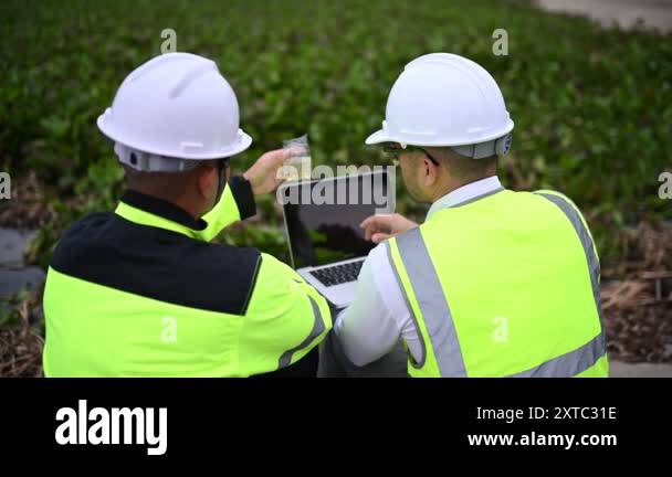 Environmental engineers work at water source to check for contaminants in water sources and ...