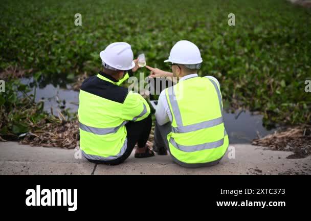Environmental engineers work at water source to check for contaminants in water sources and ...