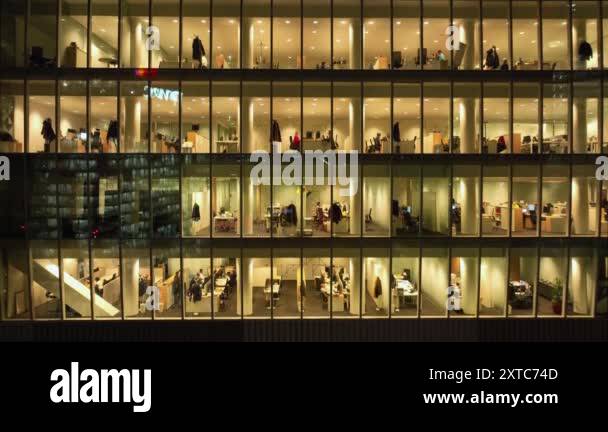 Drone flies up panning the facade of a skyscraper with office space at ...